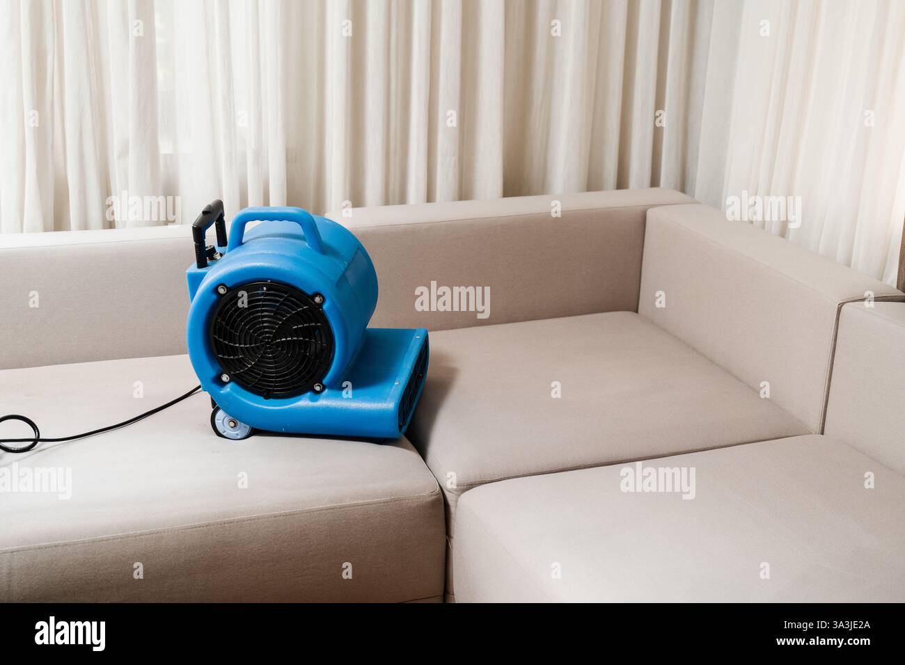 Floor dryer blower fan machine drying wet couch after dry cleaning of ...