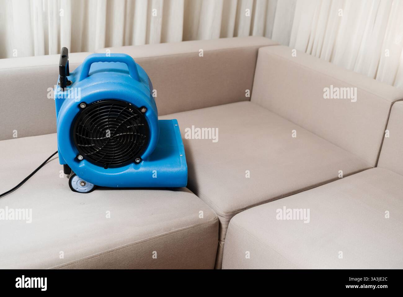 Floor dryer blower fan machine drying wet couch after dry cleaning of ...