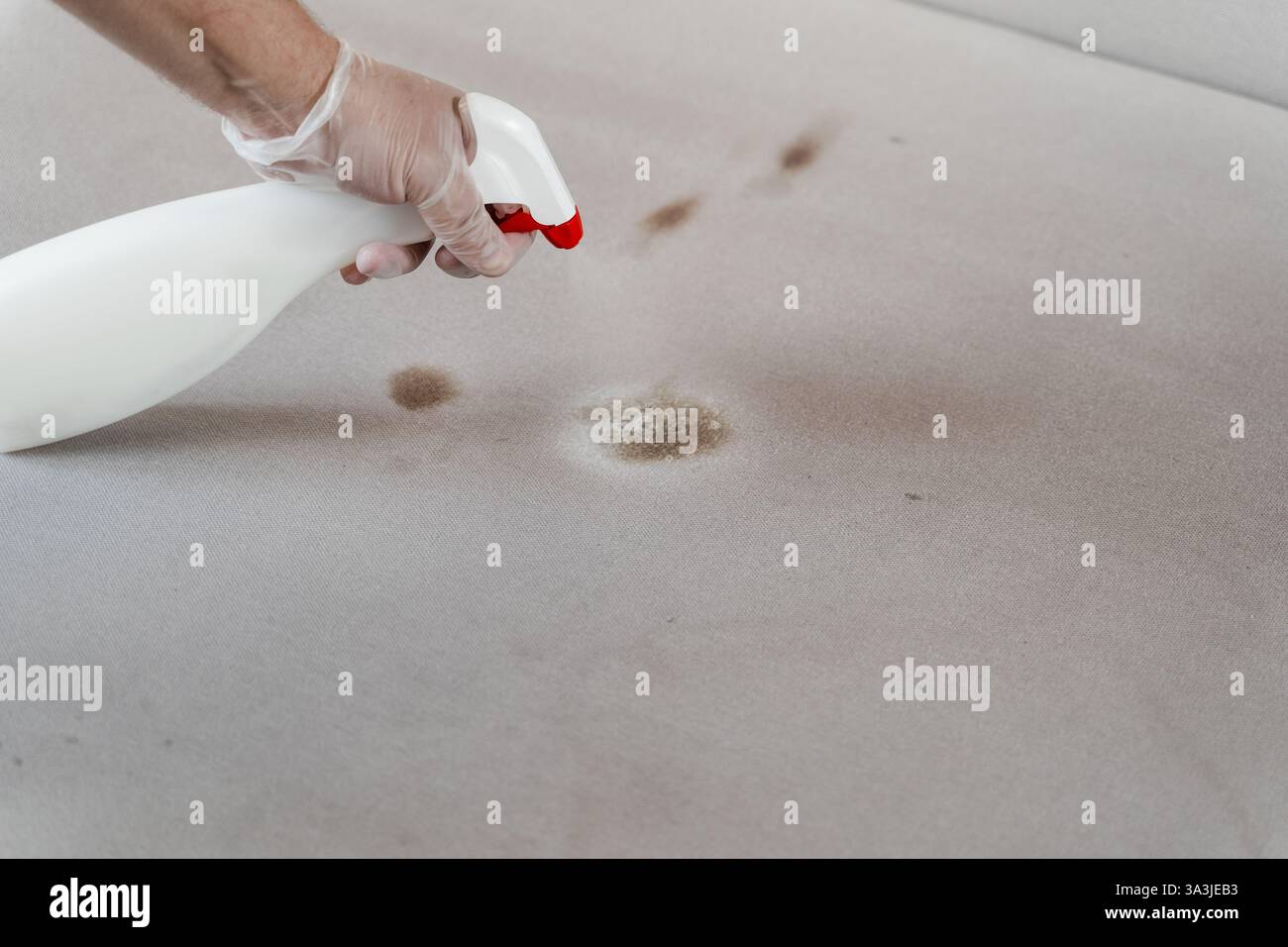 Cleaner is spraying dry cleaning chemicals detergent to clean and ...