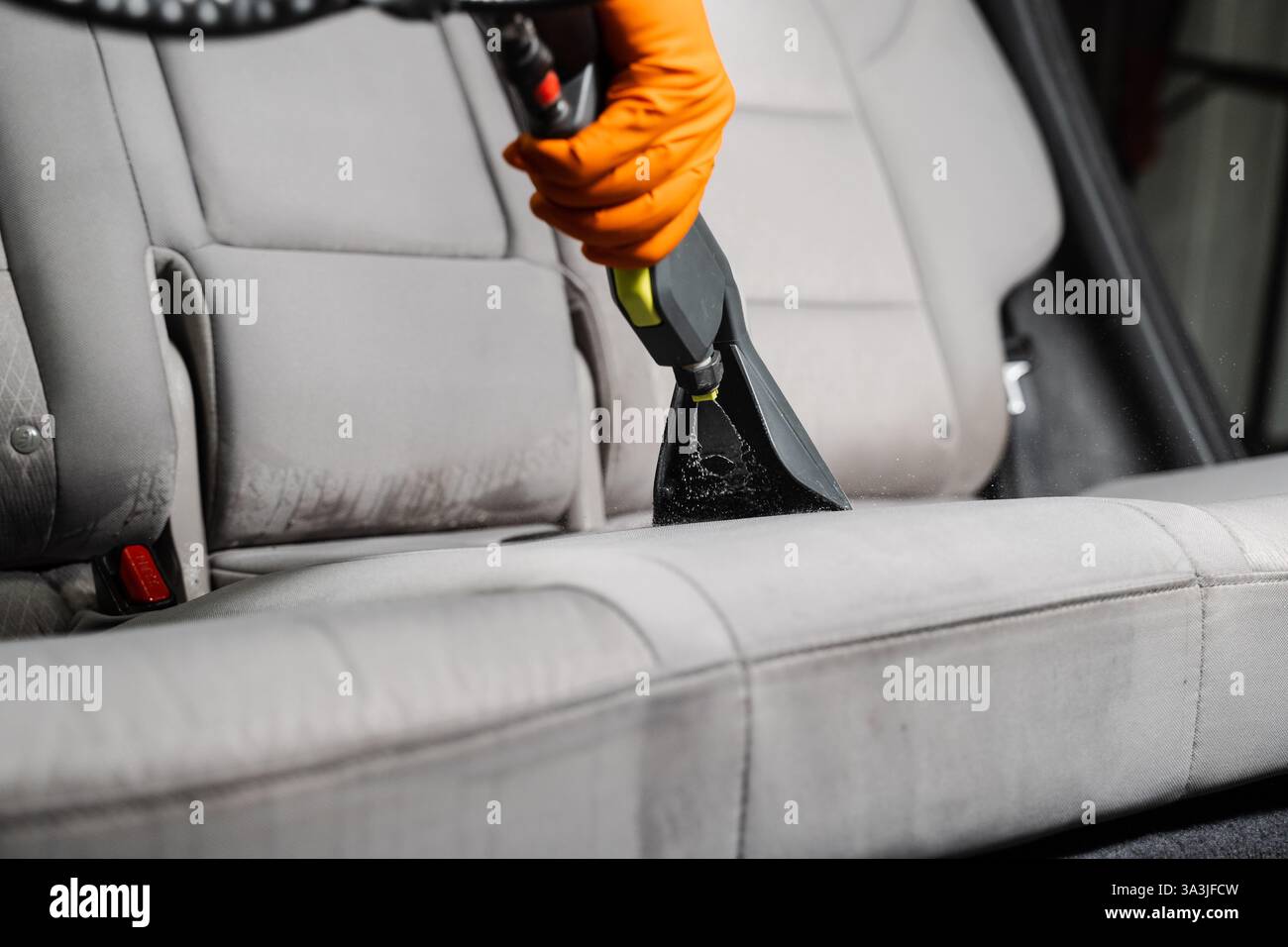 Close-up dry cleaning extractor machine is spraying water and detergent ...