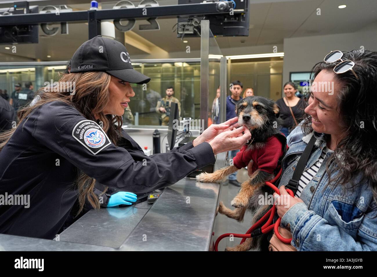 Homeland Security Secretary Kristi Noem, left, greets Jessica Medina ...