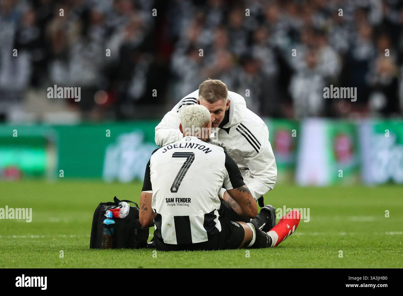 Joelinton of Newcastle United receives medical treatment during the ...