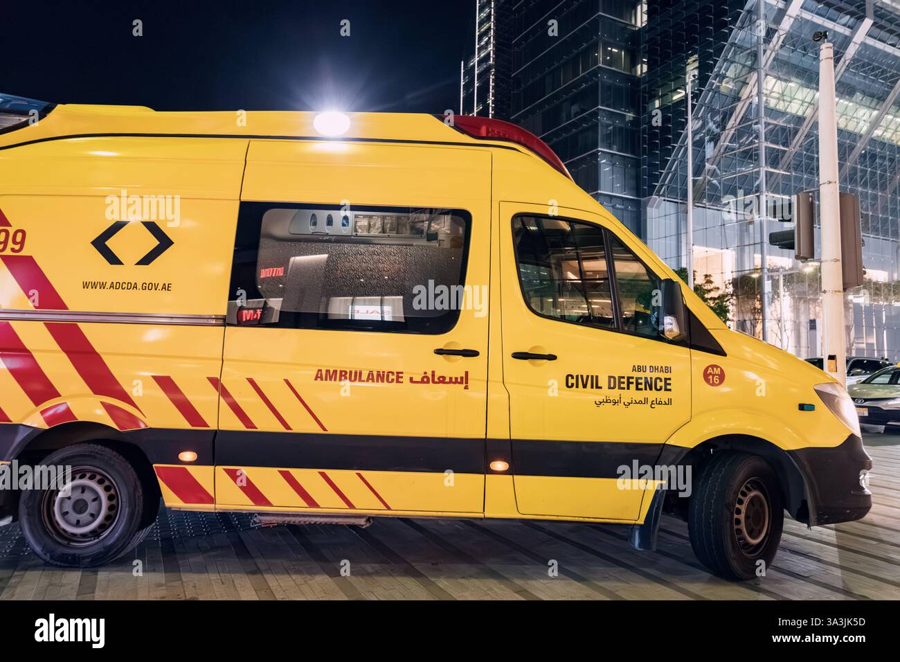 17 January 2025, Abu Dhabi, UAE: Yellow ambulance at the city street ...