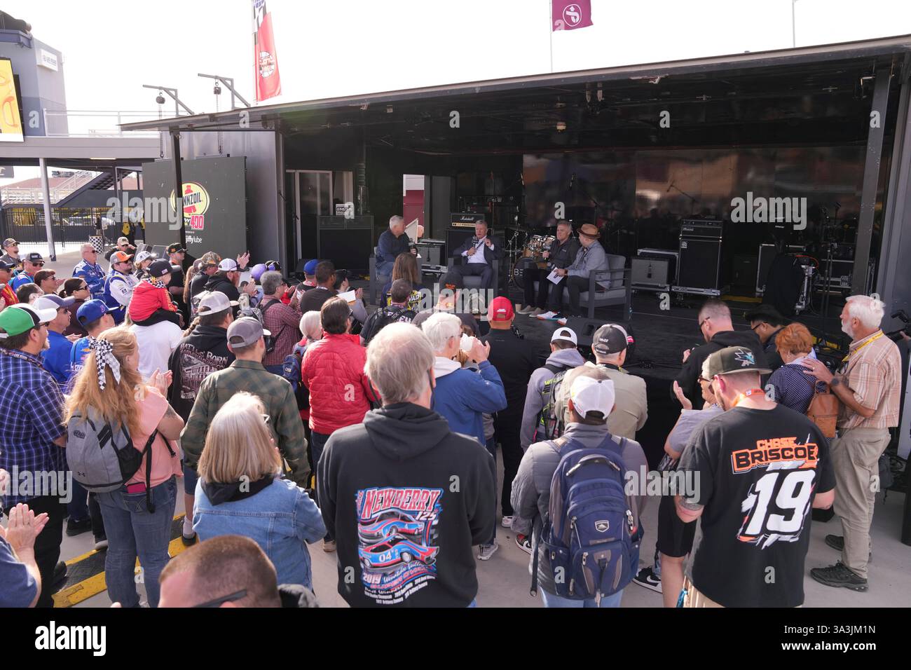 LAS VEGAS, NV - MARCH 16: Fans watch (L-R) John Roberts, LVMS Track President Chris Powell ...