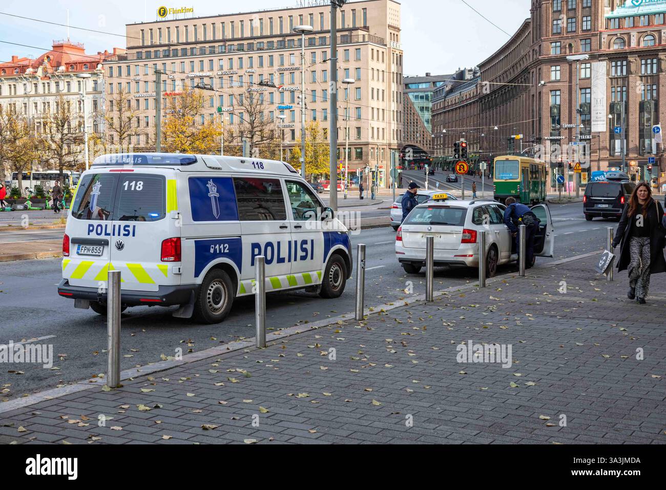 Police officers with stopped taxi car on Kaivokatu in Kluuvi district ...