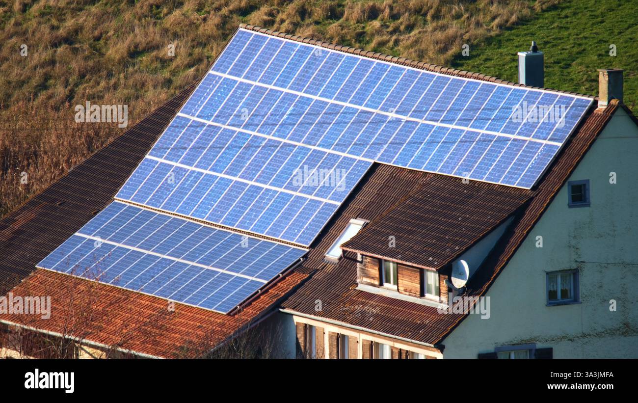 Solar panels installed on a residential roof in a countryside setting ...