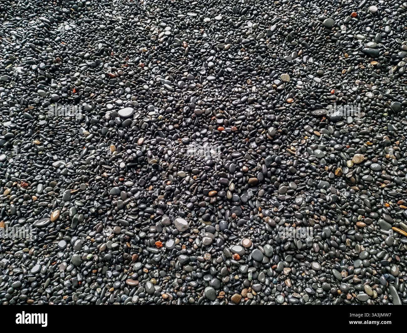 Background featuring wet basalt pebbles creating the striking landscape ...