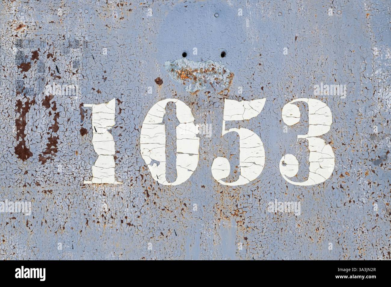 Old rusty metal plaque with numbers in center Stock Photo - Alamy