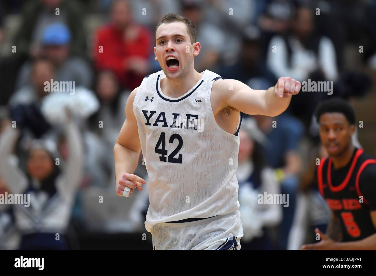 Yale forward Nick Townsend (42) celebrates in front of Cornell guard ...
