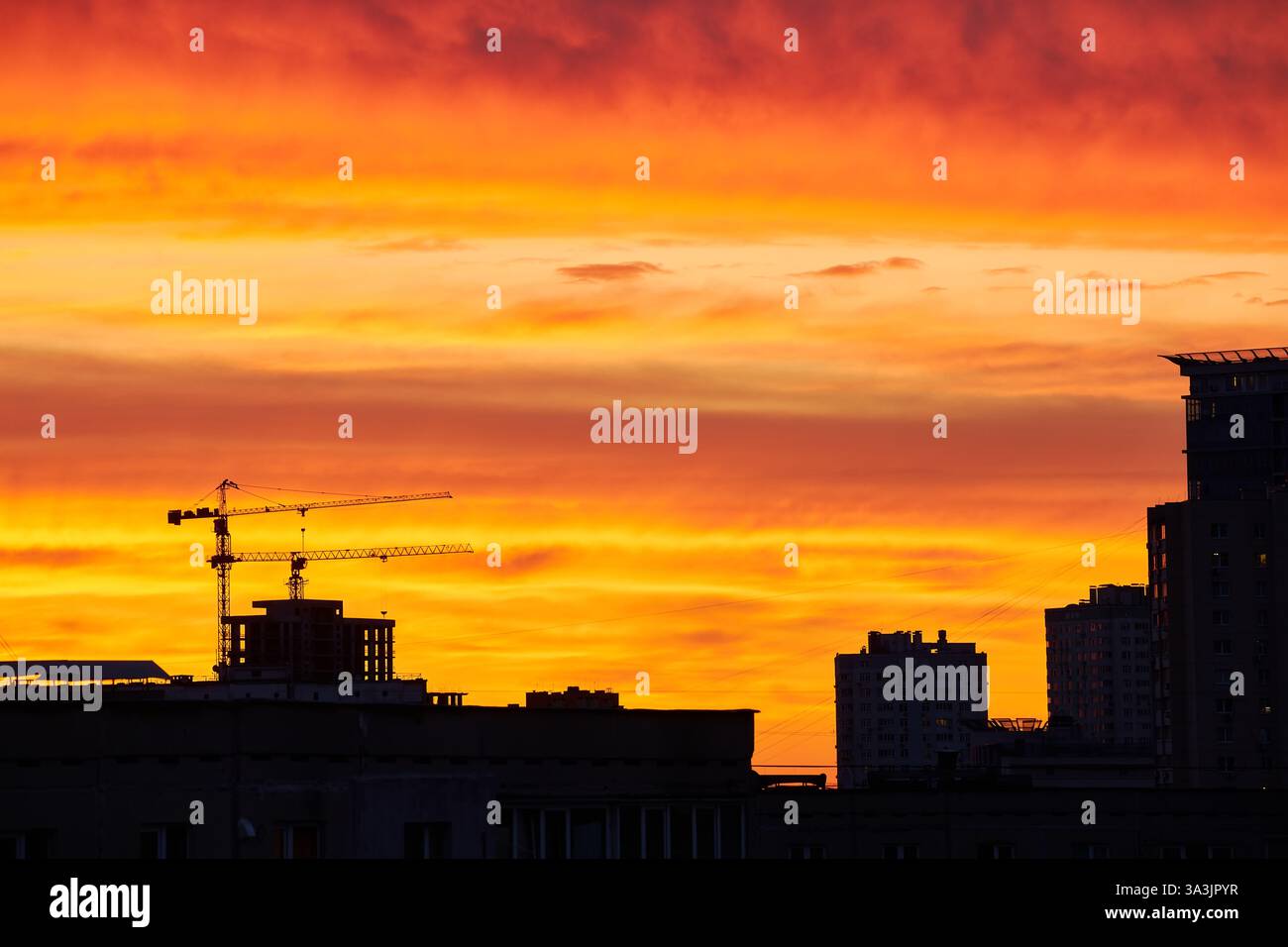 A stunning sunset bathes the city skyline in warm golden light. The sun dips behind buildings ...