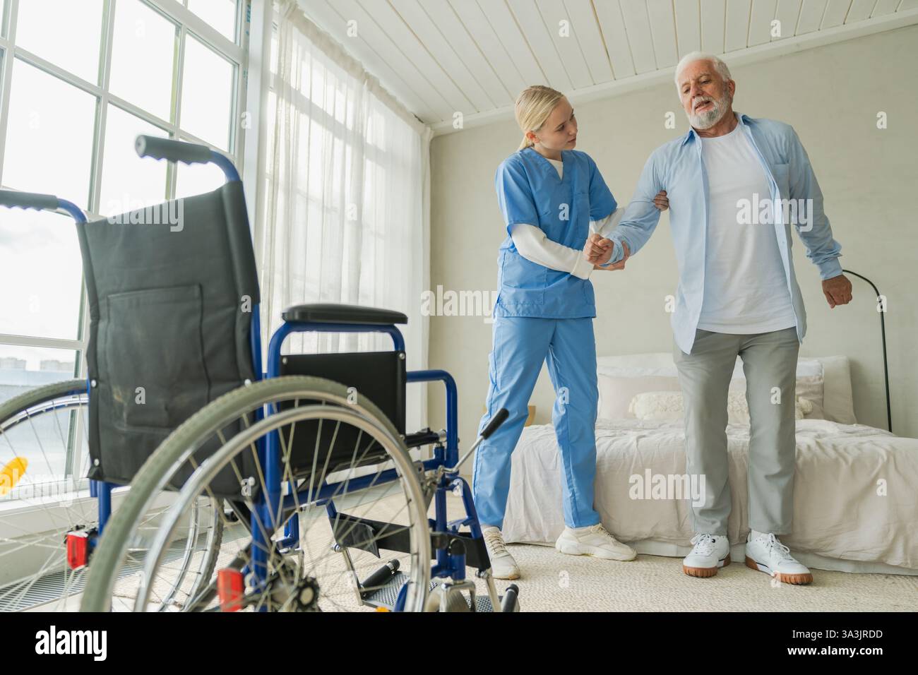 Rehabilitation healthcare. Physiotherapist nurse helps old man patient ...