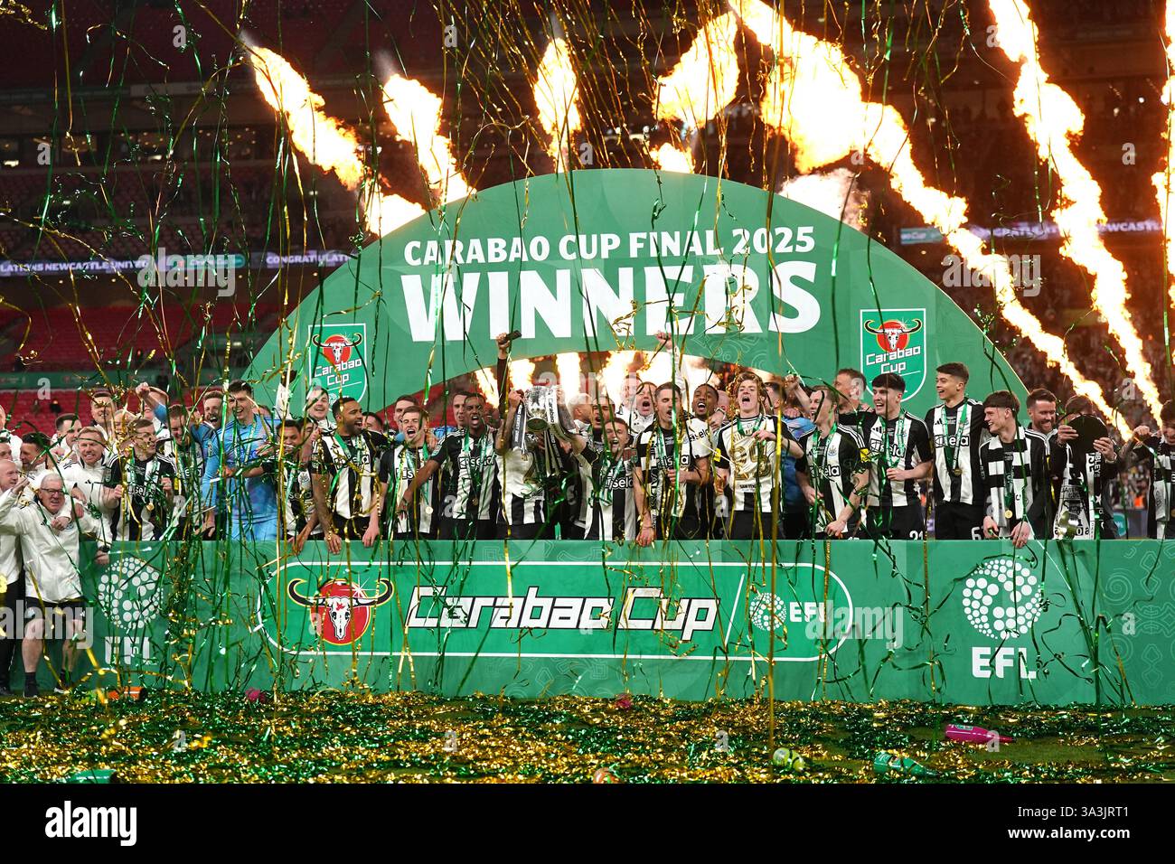 Newcastle United's Bruno Guimaraes and Kieran Trippier lift the Carabao Cup trophy with team ...