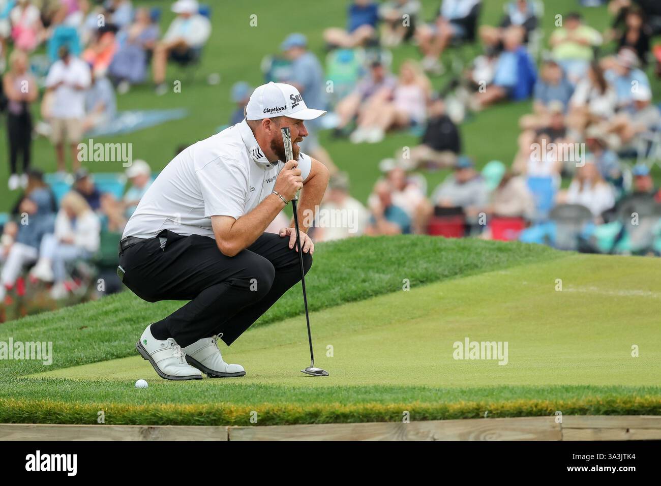 March 16, 2025: Shane Lowry sizes up his putt on the 17th hole during ...