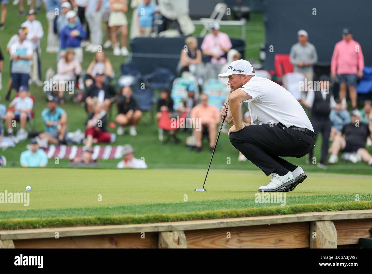 March 16, 2025: Shane Lowry sizes up his putt on the 17th hole during ...