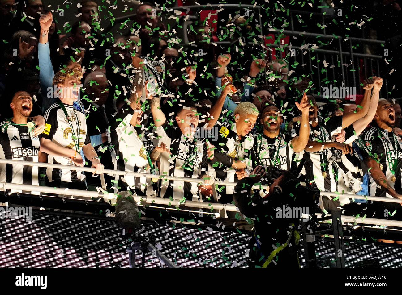 Newcastle United's Bruno Guimaraes and Kieran Trippier lift the trophy ...