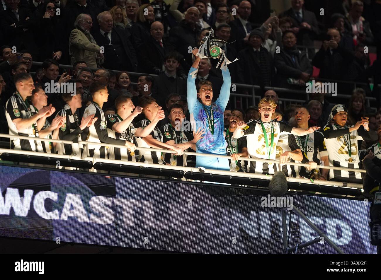 Newcastle United goalkeeper Nick Pope lifts the Carabao Cup trophy with ...
