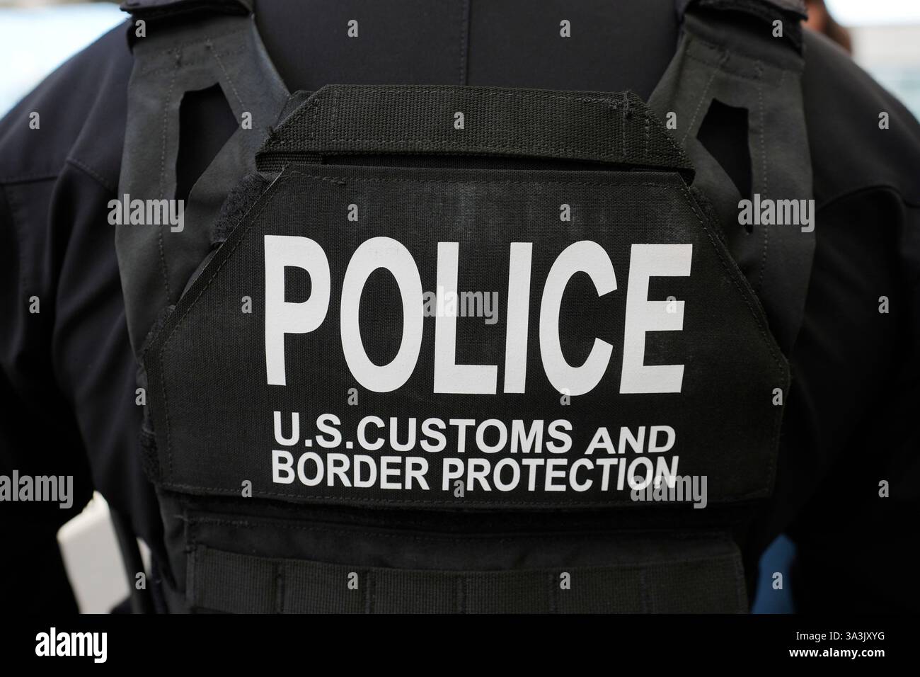A Customs and Border Patrol officer watches as Homeland Security ...