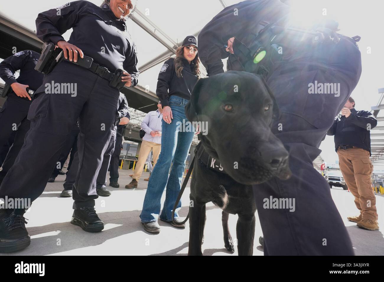 Homeland Security Secretary Kristi Noem, center, looks at Dublin, a ...
