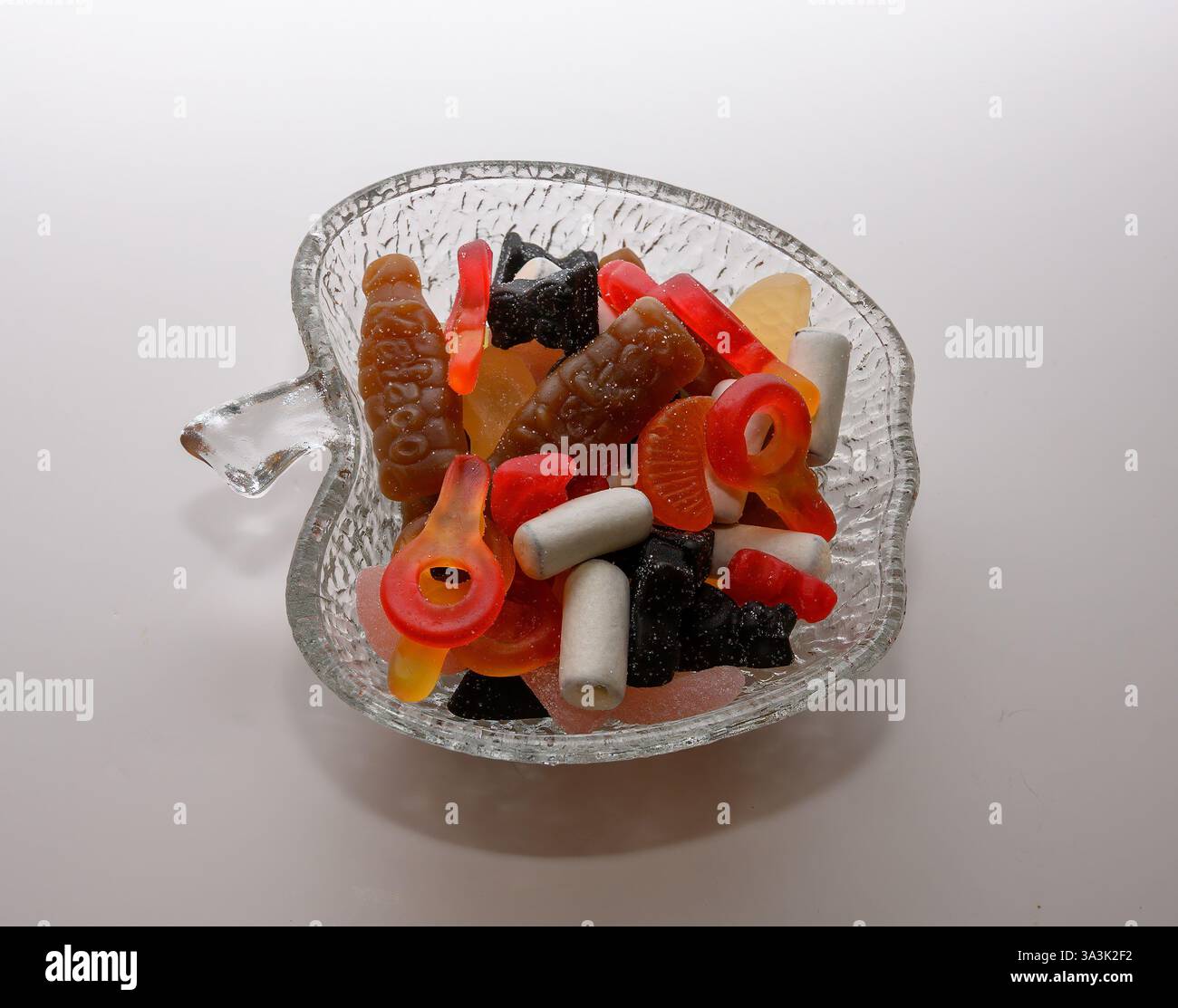 A variety of vibrant candies, including gummy shapes and licorice ...