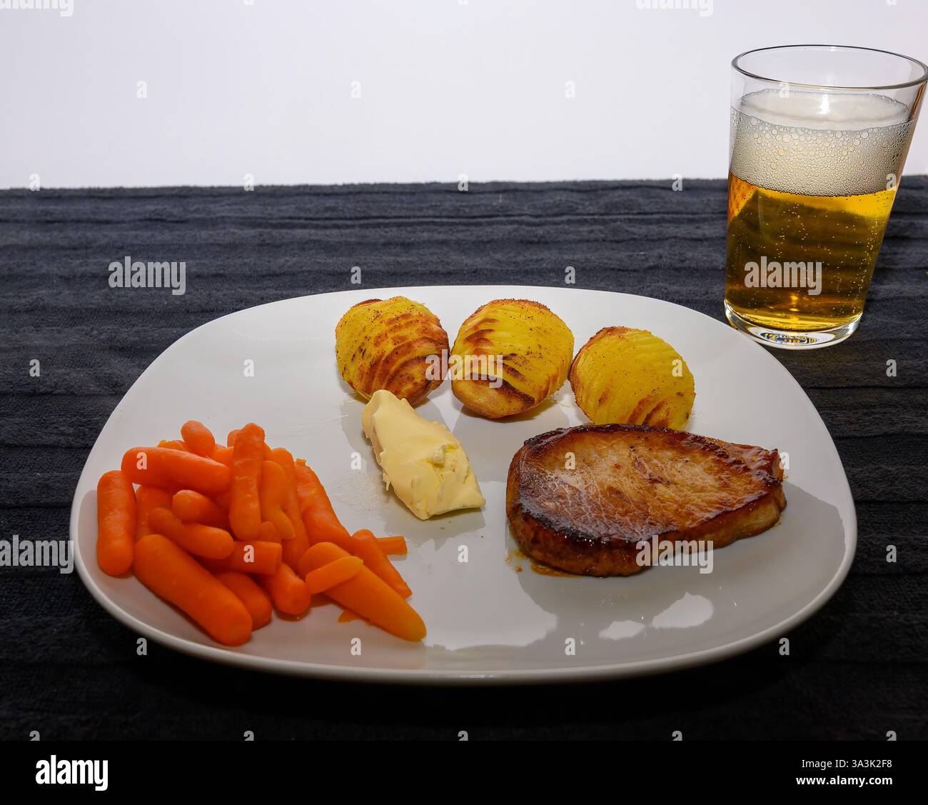 A well-prepared dinner plate displays a succulent pork chop alongside ...