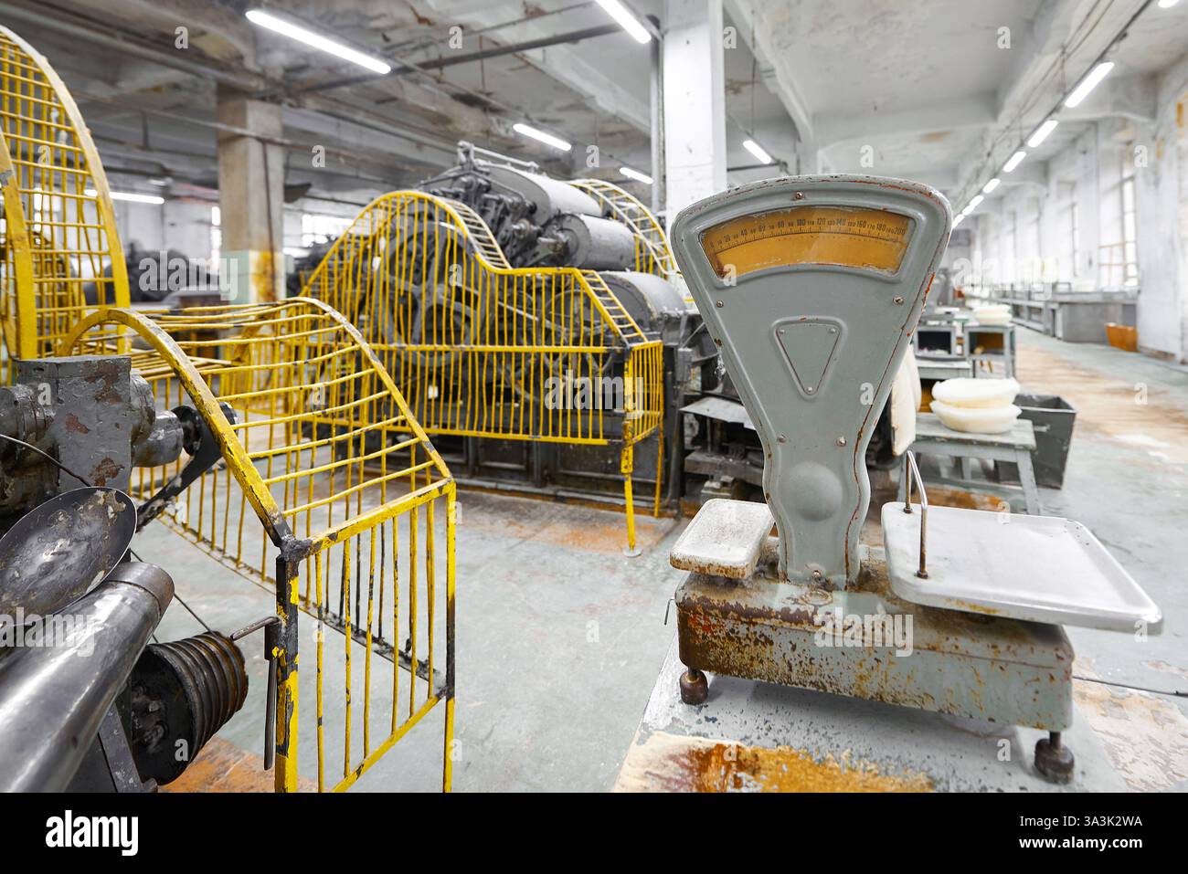 Vintage weighing scale in an industrial environment reflecting years of ...