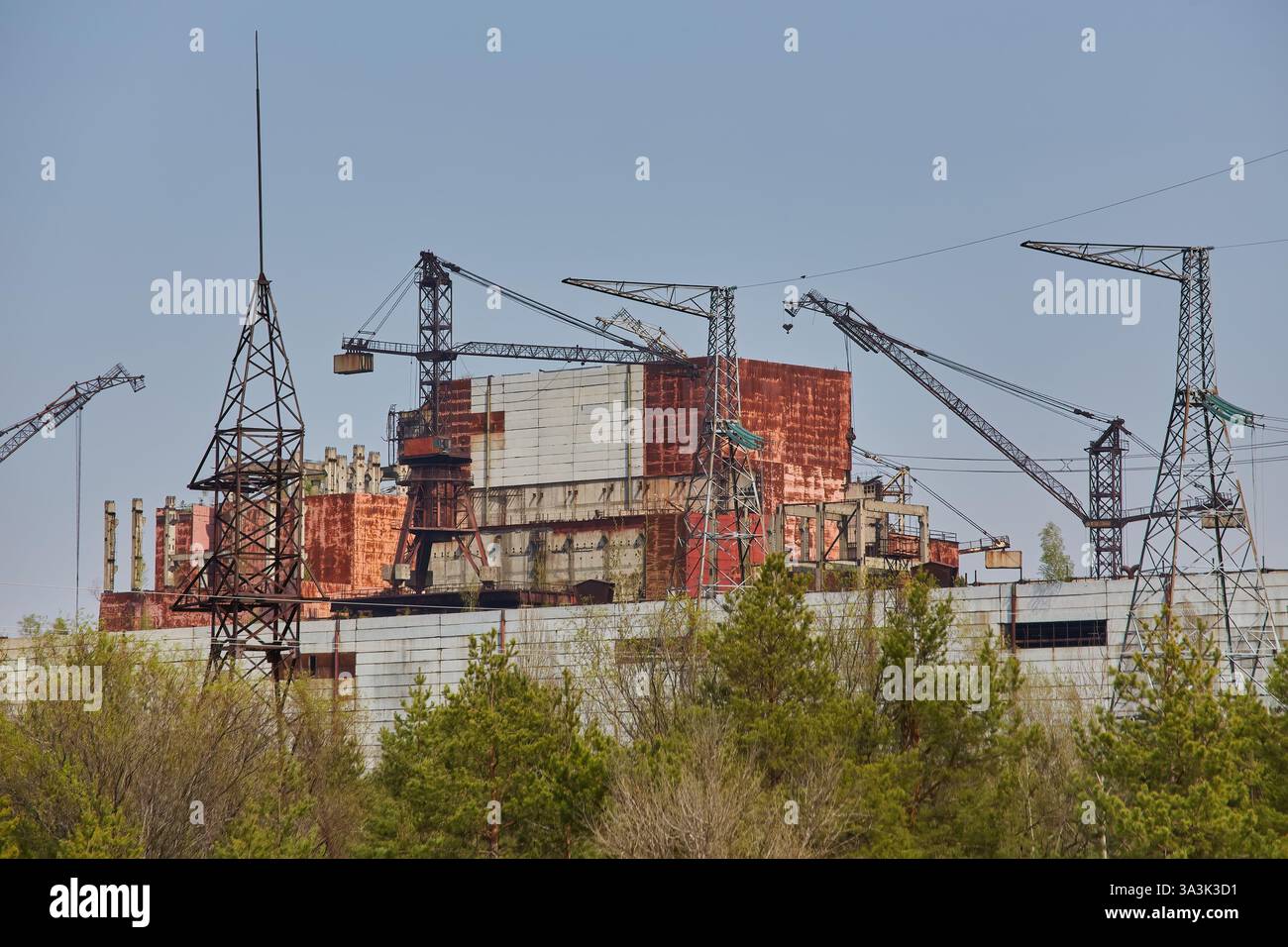 Partially constructed and abandoned reactor buildings with cranes and ...