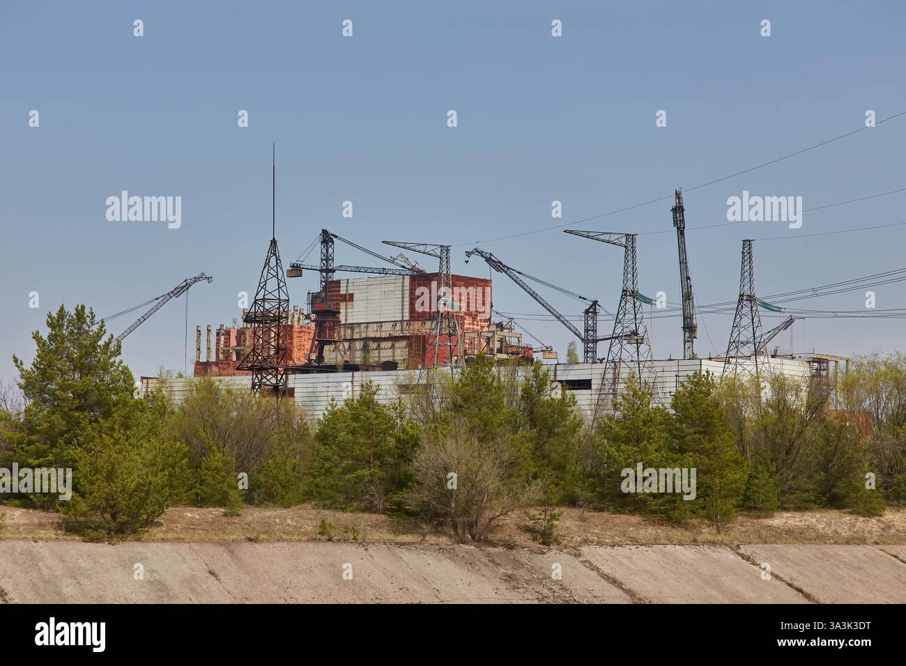 Partially constructed and abandoned reactor buildings with cranes and ...