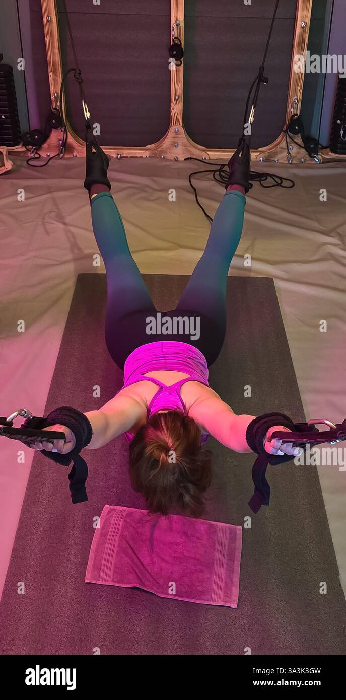 Fitness enthusiast performing back strengthening exercise using ...