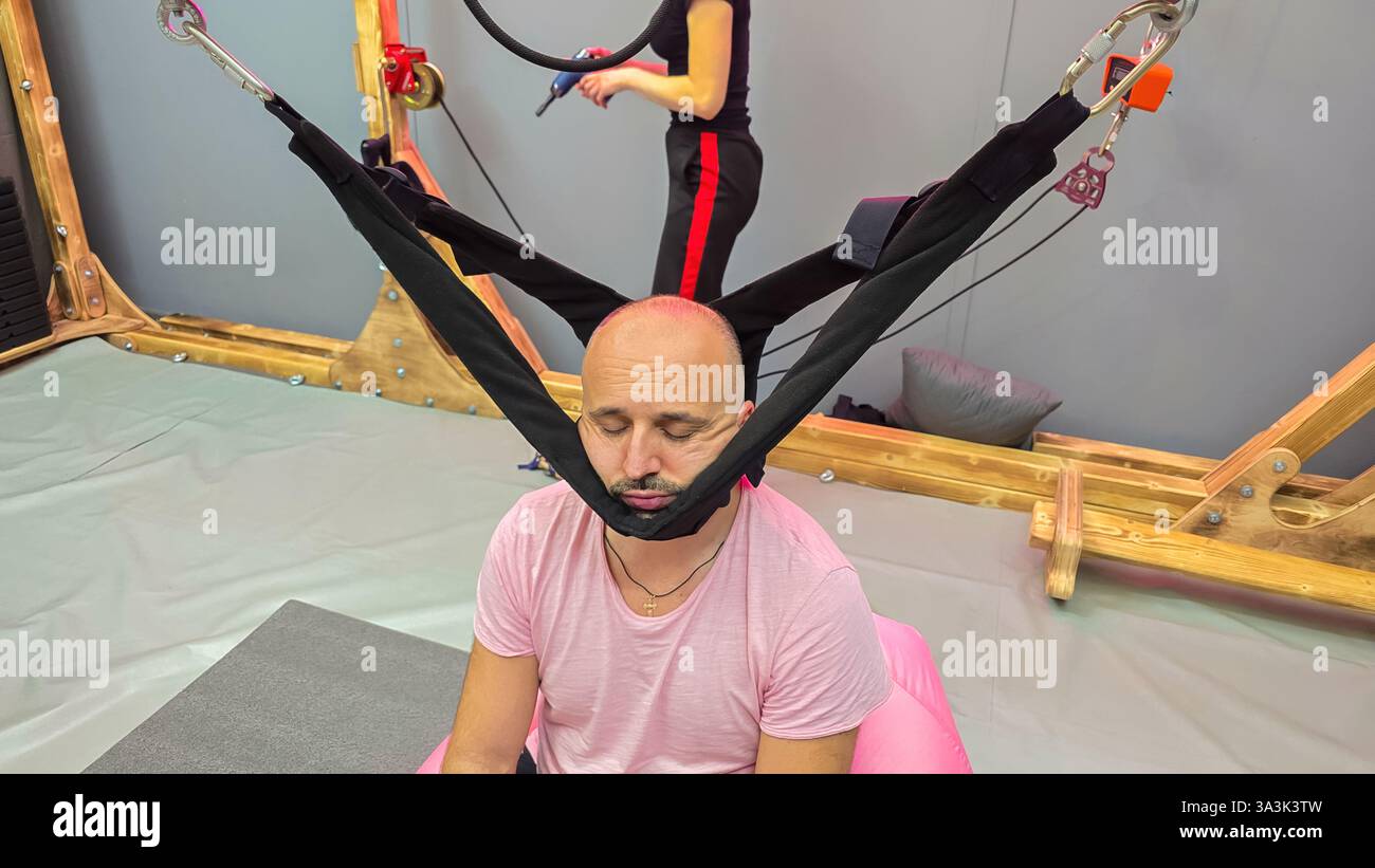 Medical professional adjusting equipment while patient undergoes ...