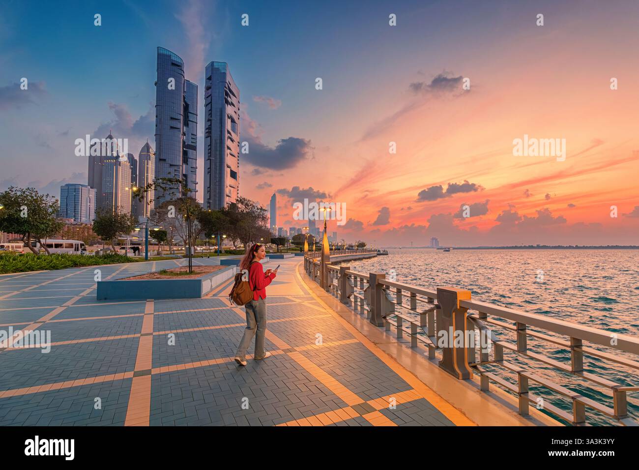 Walking along the Abu Dhabi Corniche promenade at sunset, enjoying the ...