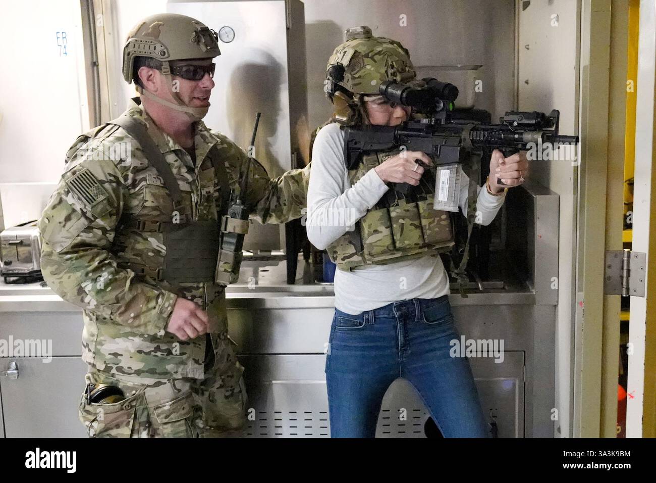 Homeland Security Secretary Kristi Noem, right, participates in ship ...