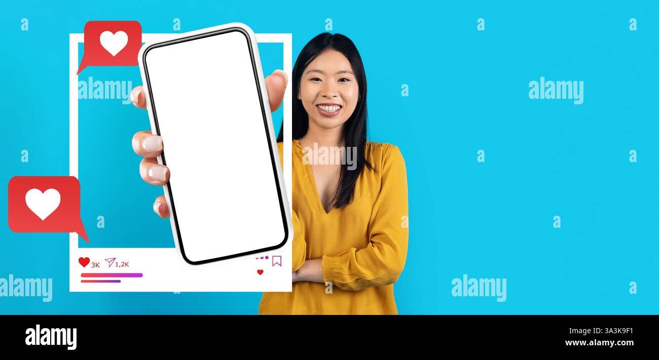 Influencer promotes smartphone with social media app on blue backdrop ...