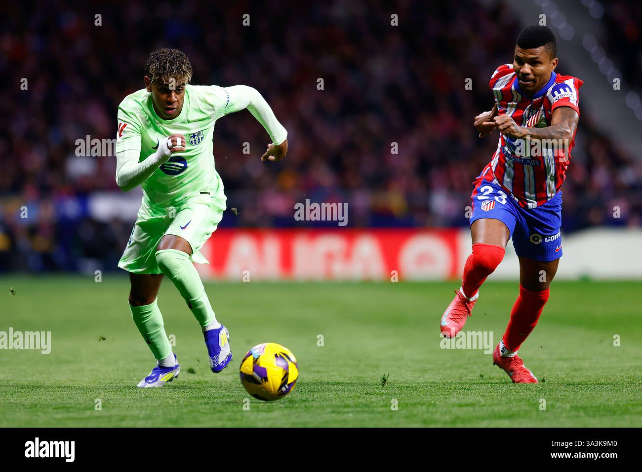 Lamine Yamal of FC Barcelona and Reinildo Mandava of Atletico de Madrid ...