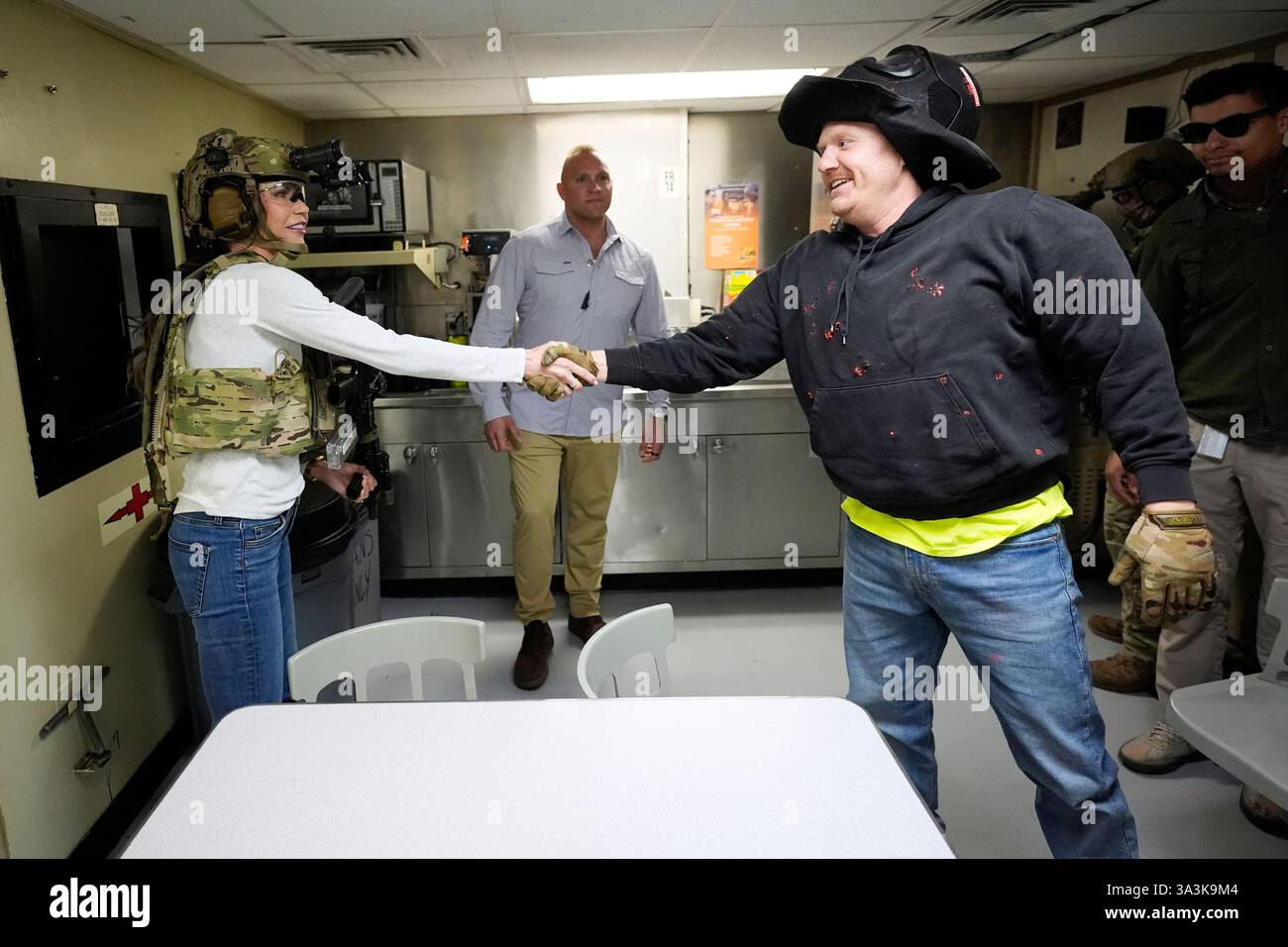 Homeland Security Secretary Kristi Noem, left, greets a member of the ...