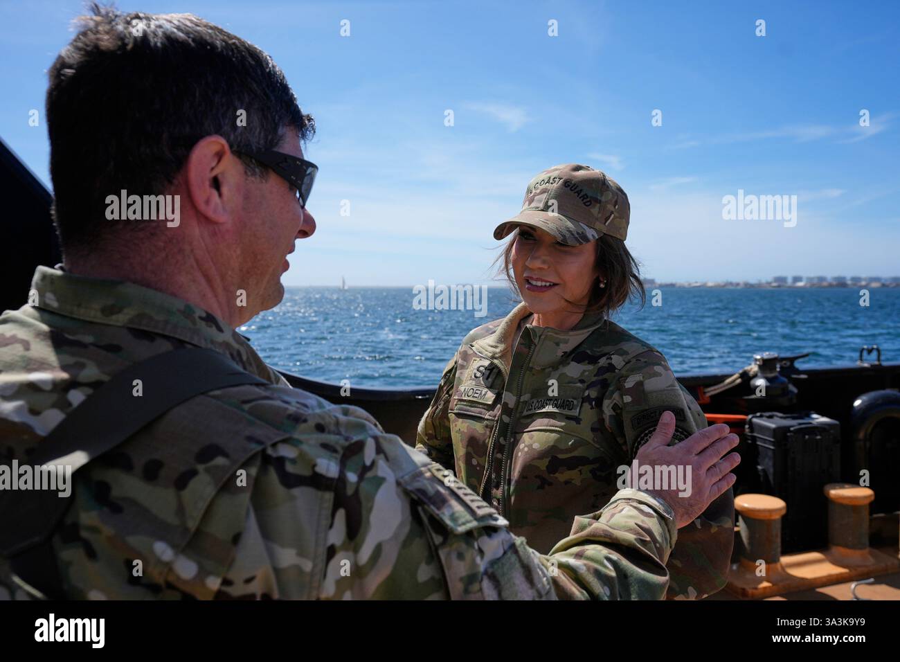Homeland Security Secretary Kristi Noem, right, receives a U.S. Coast ...