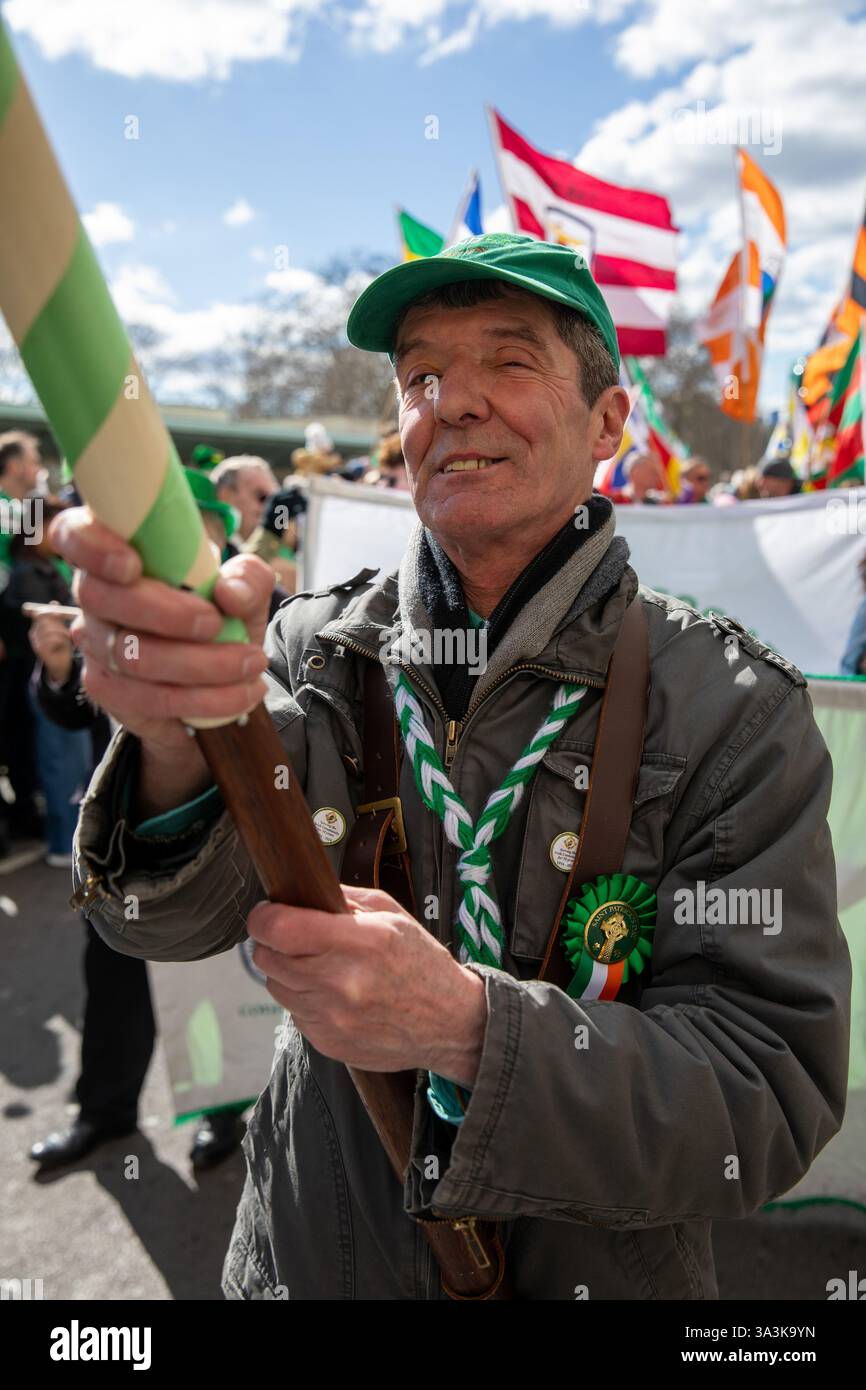 A man holds a flag pole during the parade. Thousands took part in the ...