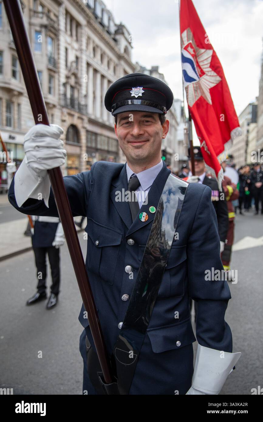 London, UK. 16th Mar, 2025. A member of the Fire brigade holds a flag ...