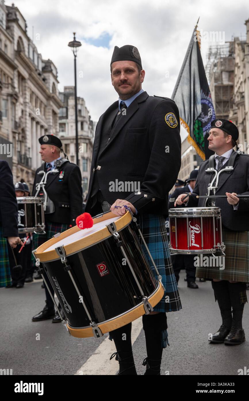 London, UK. 16th Mar, 2025. A drummer poses for photograph during the ...