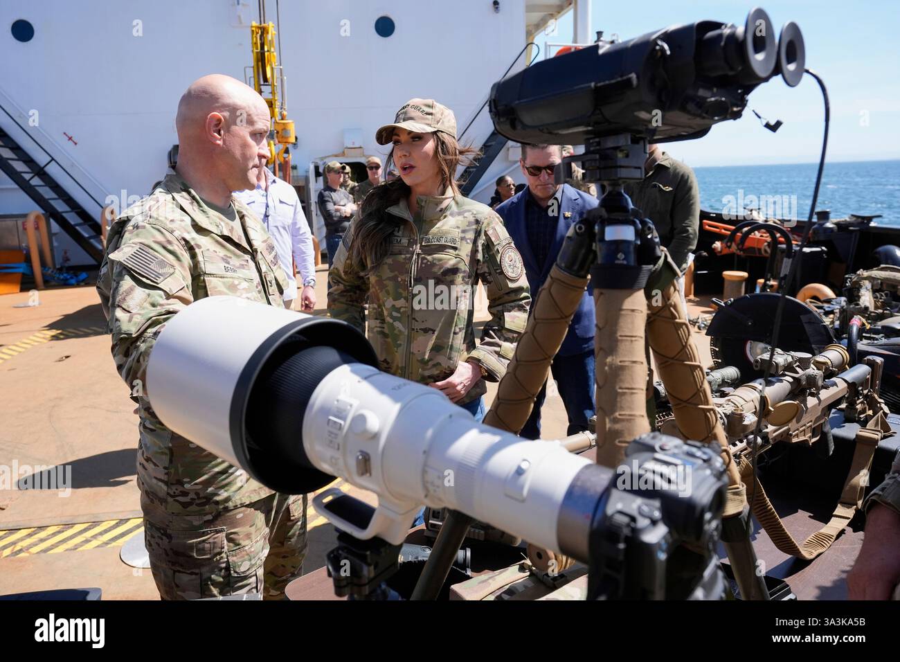 Homeland Security Secretary Kristi Noem, right, looks at equipment ...
