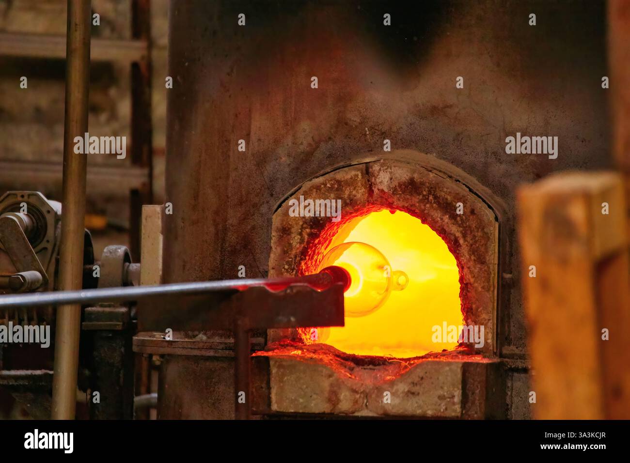 Murano glass-blowing factory. blower forming beautiful piece of glass ...
