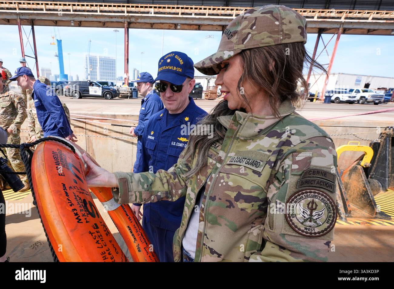 Homeland Security Secretary Kristi Noem, right, holds a signed life ...