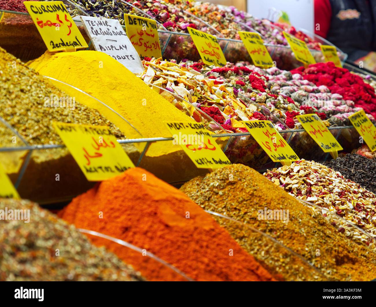 Vibrant array of spices and dried goods with price tags in a market ...