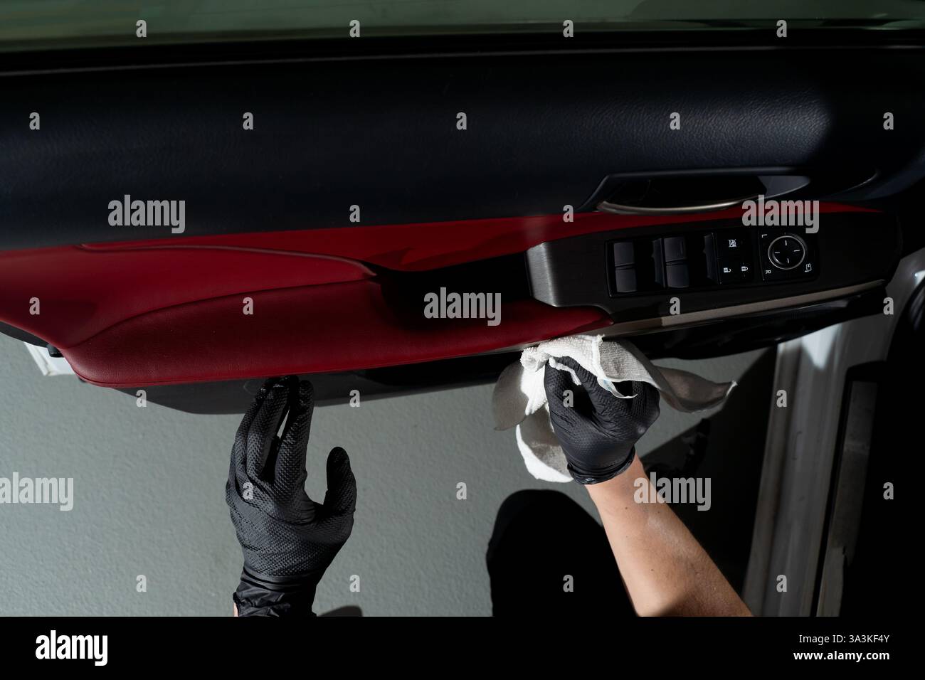 Removing dust and dirt from leather auto car panel using microfiber rag ...