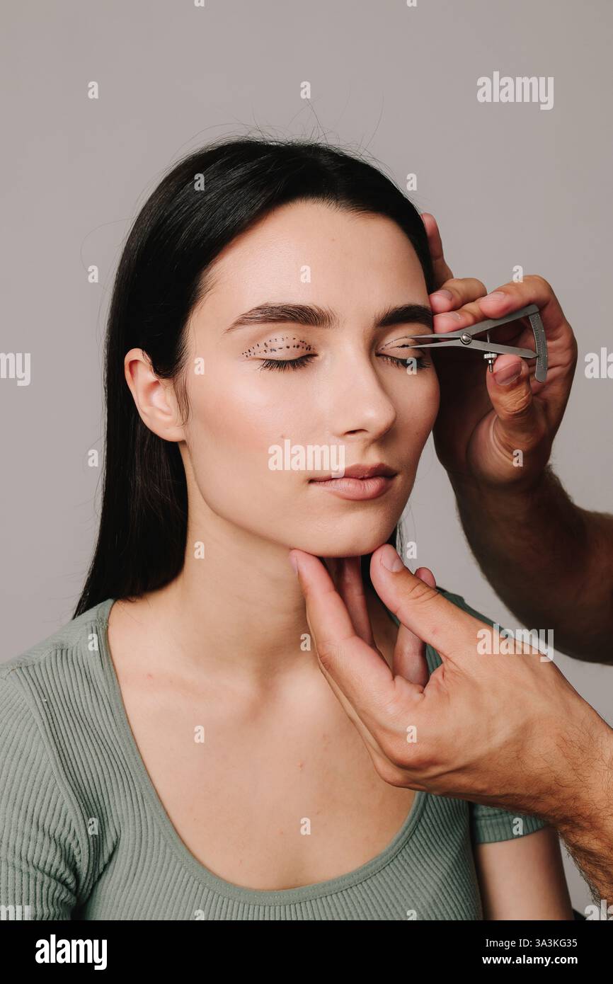 Blepharoplasty marking up. Plastic surgeon is measuring distance in ...