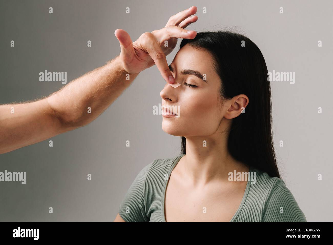 Rhinoplasty. Plastic surgeon is taping nose to patient during ...