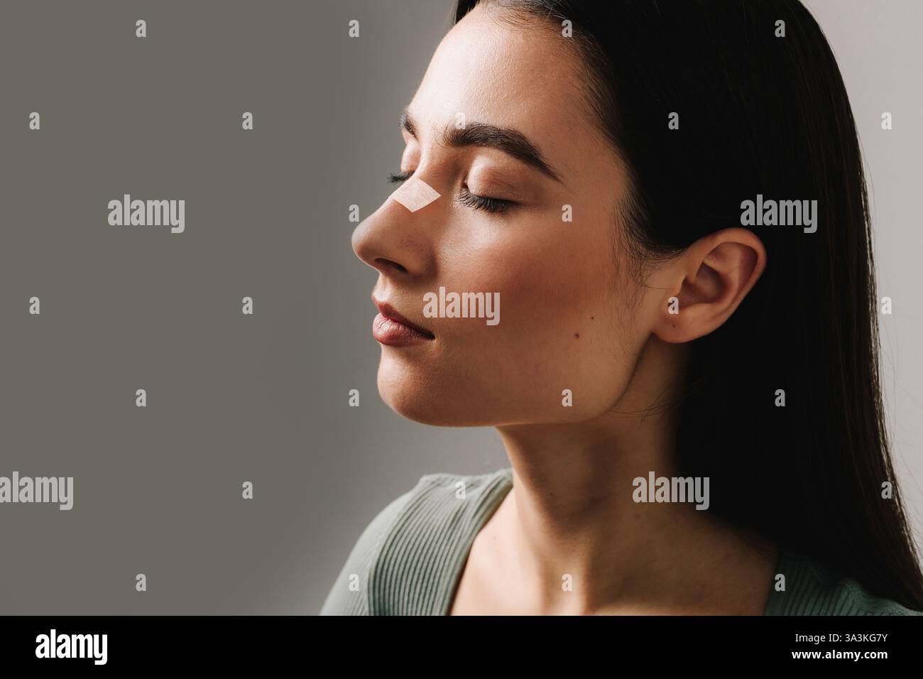 Rhinoplasty. Applying bandage on nose after surgery to support its ...