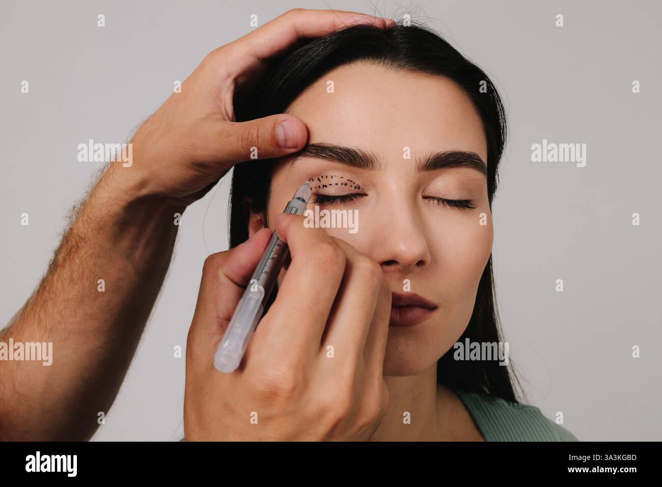 Marking blepharoplasty. Doctor is drawing up plan for upper eye lid ...