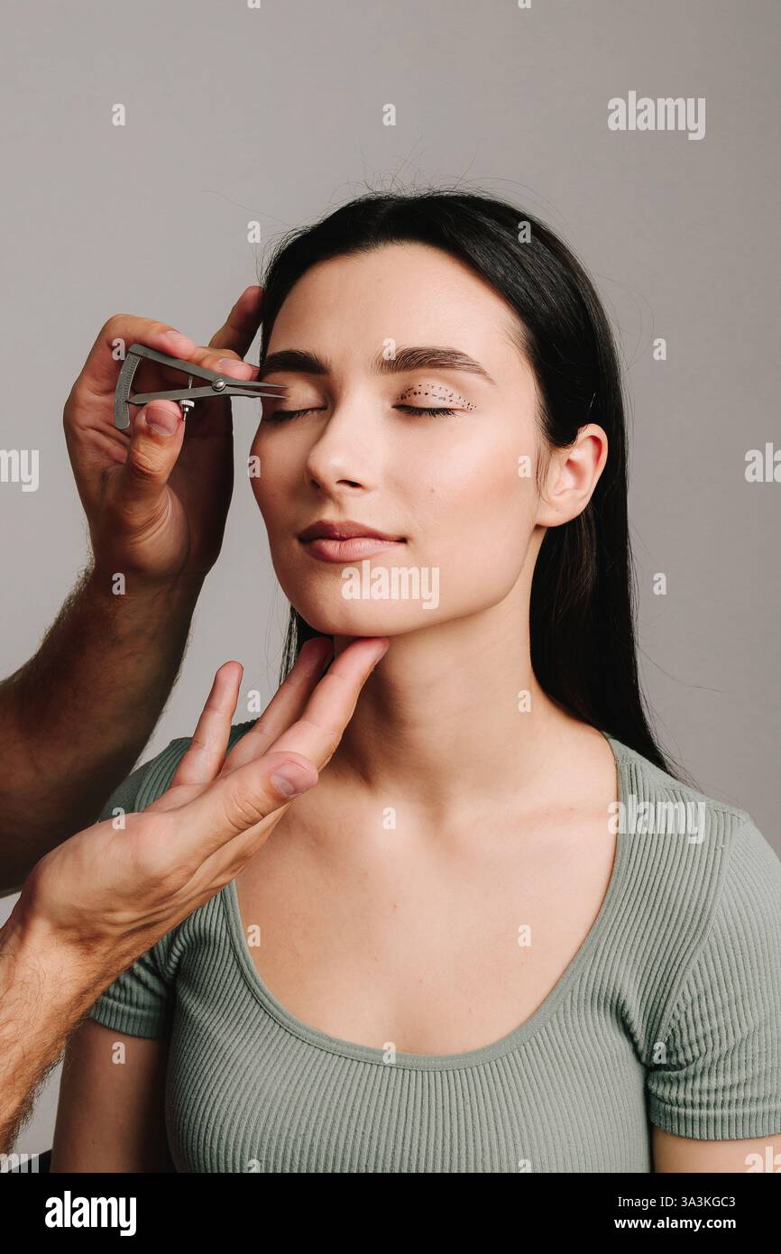 Blepharoplasty marking up. Plastic surgeon is measuring distance in ...