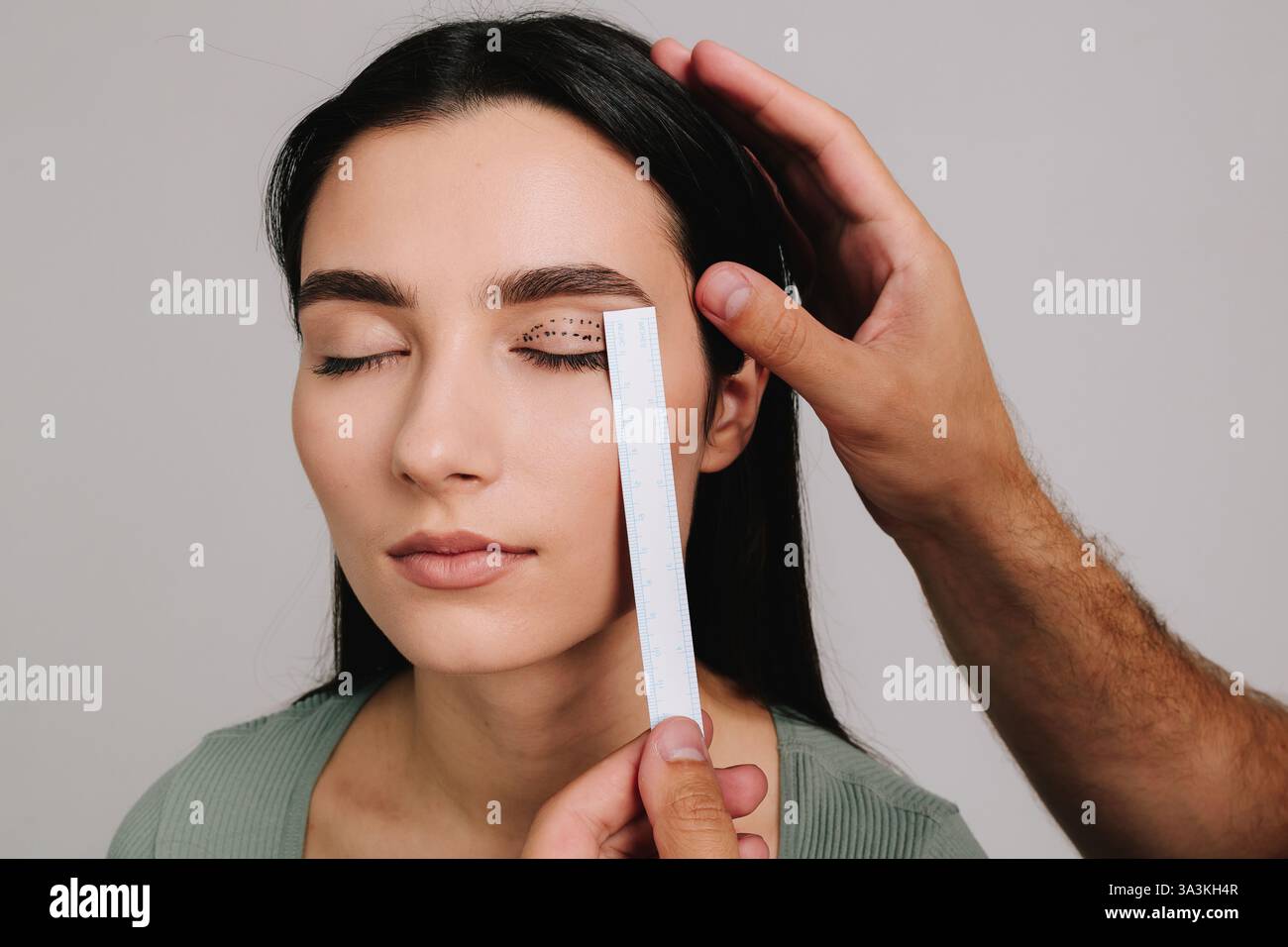 Blepharoplasty. Plastic surgeon is measuring surgical distance within ...