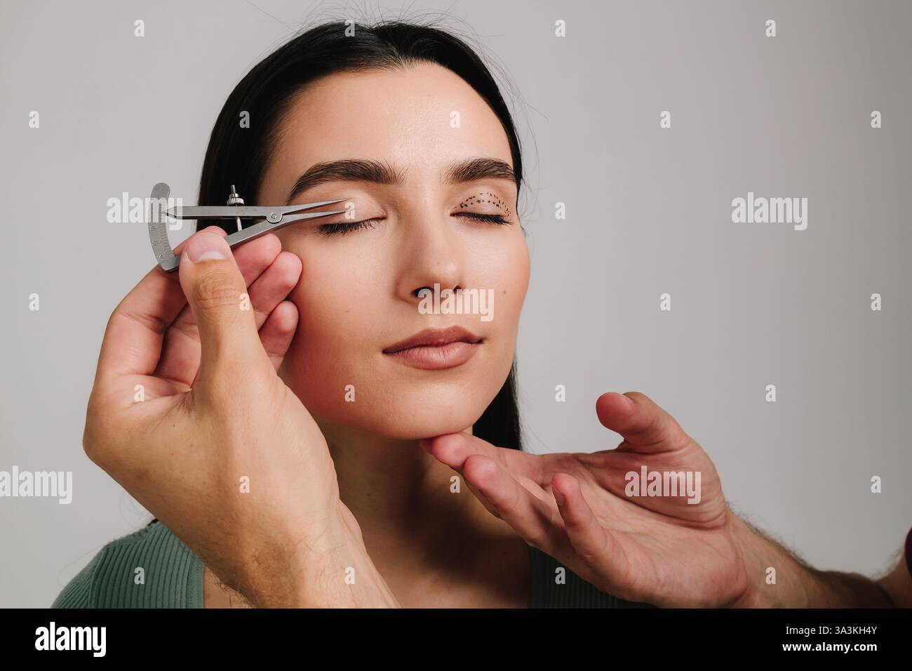 Upper blepharoplasty. Plastic surgeon is measuring surgical distance ...